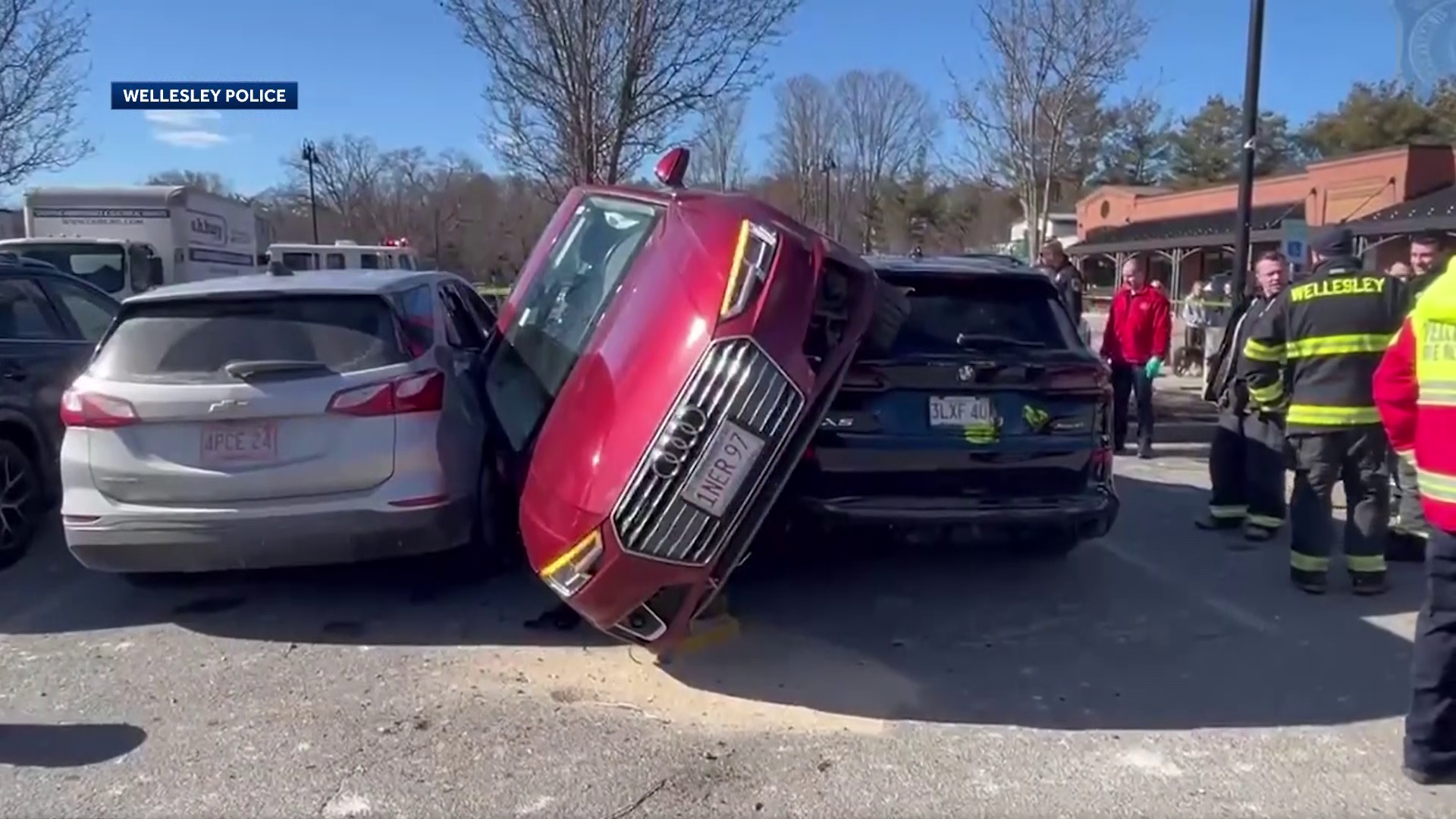 How'd this happen? Car wedged between vehicles in grocery store parking lot