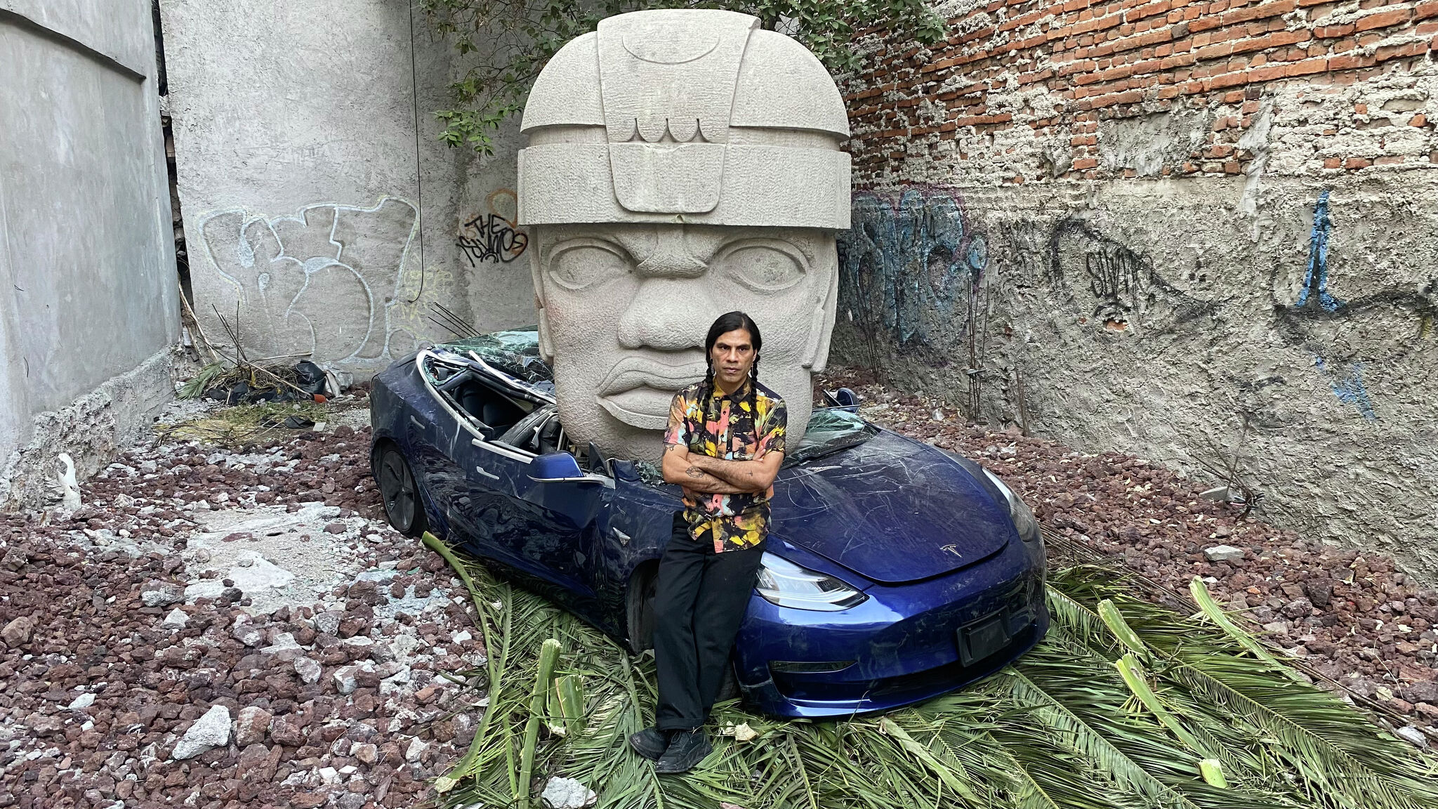 Mexican artist destroys a Tesla with 9-ton Olmec head