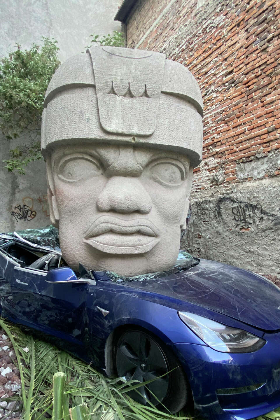 Mexican artist destroys a Tesla with 9-ton Olmec head