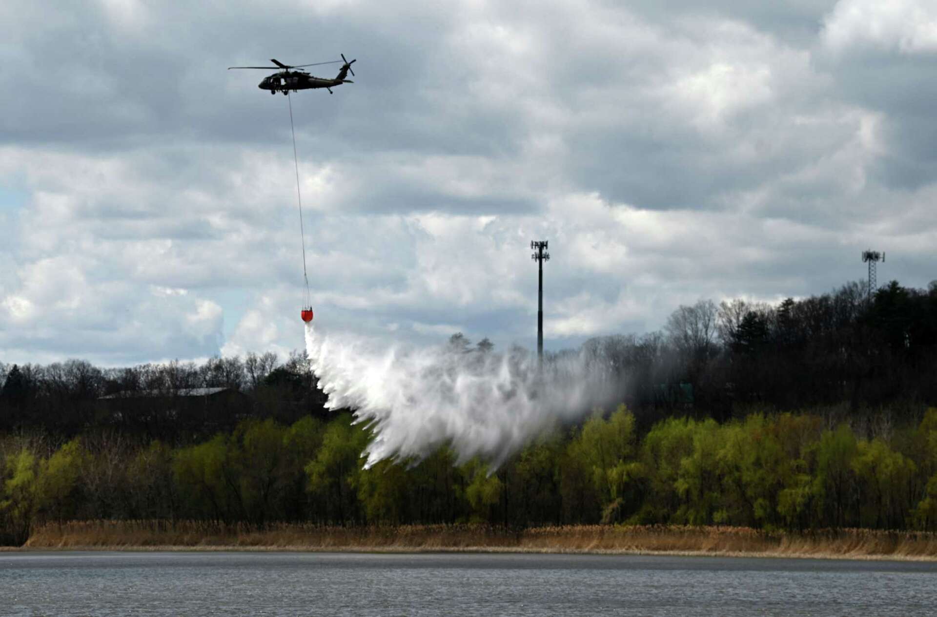 Bucket-bearing helicopter crews drill on Mohawk River in Colonie