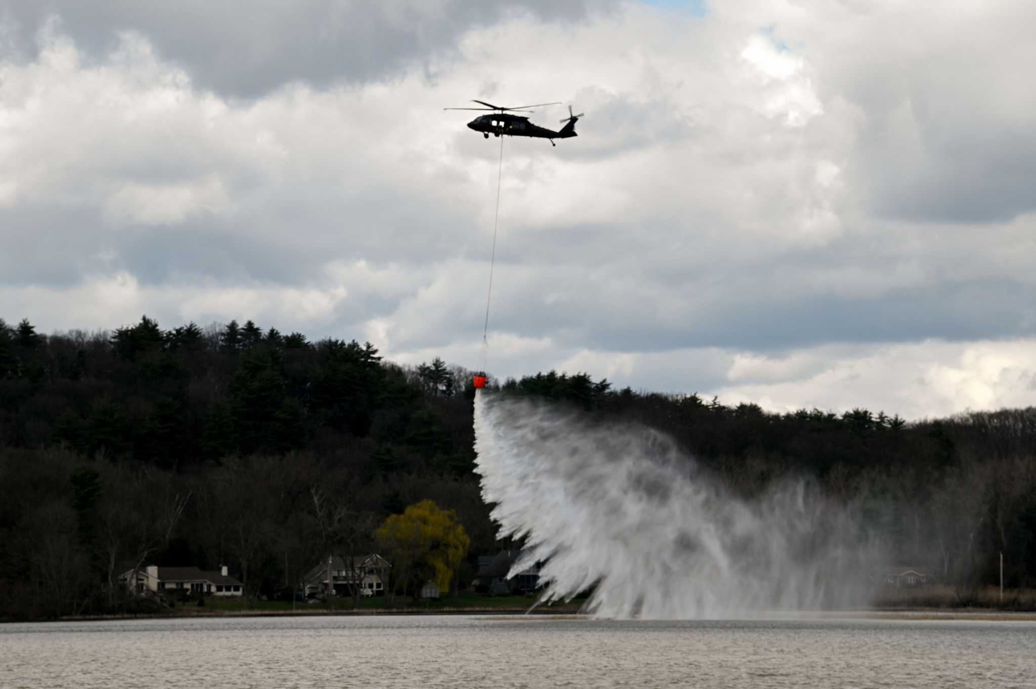 Bucket-bearing helicopter crews drill on Mohawk River in Colonie