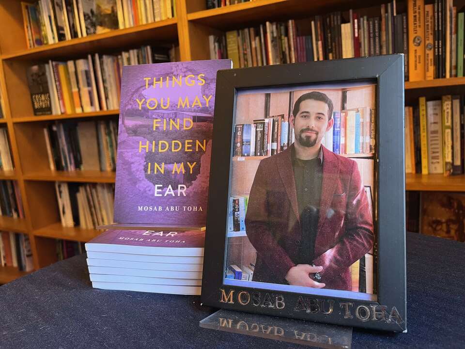 Mosab Abu Toha receives American Book Award plaque with help from S.F. Mosab Abu Toha receives American Book Award plaque with help from S.F.