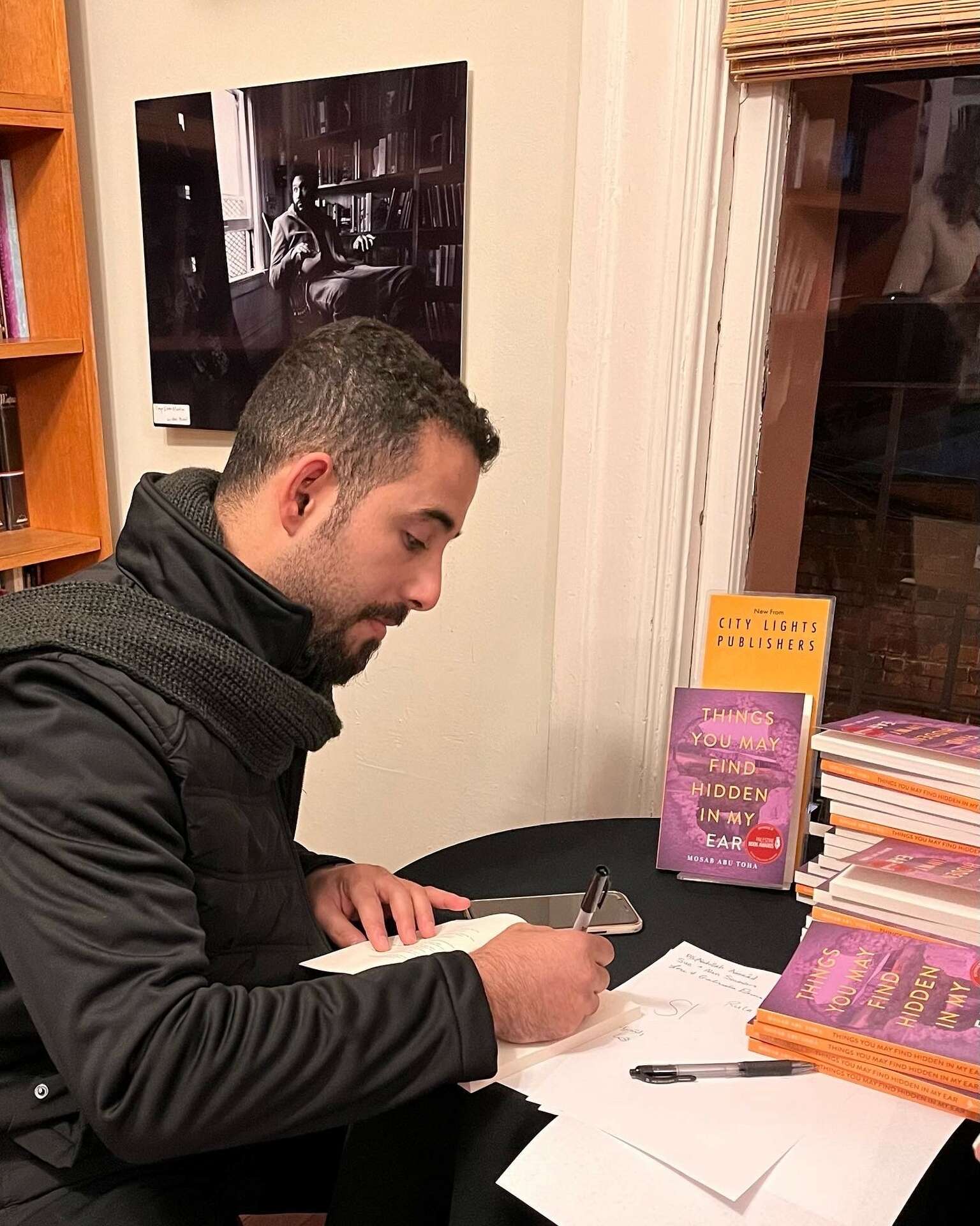 Mosab Abu Toha receives American Book Award plaque with help from S.F. Mosab Abu Toha receives American Book Award plaque with help from S.F.