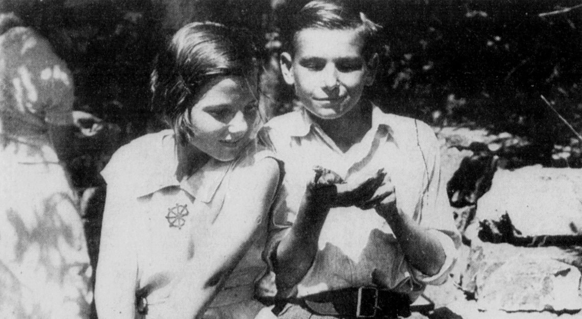 Young Oscar Brenner shows off his catch to his sister Gloria