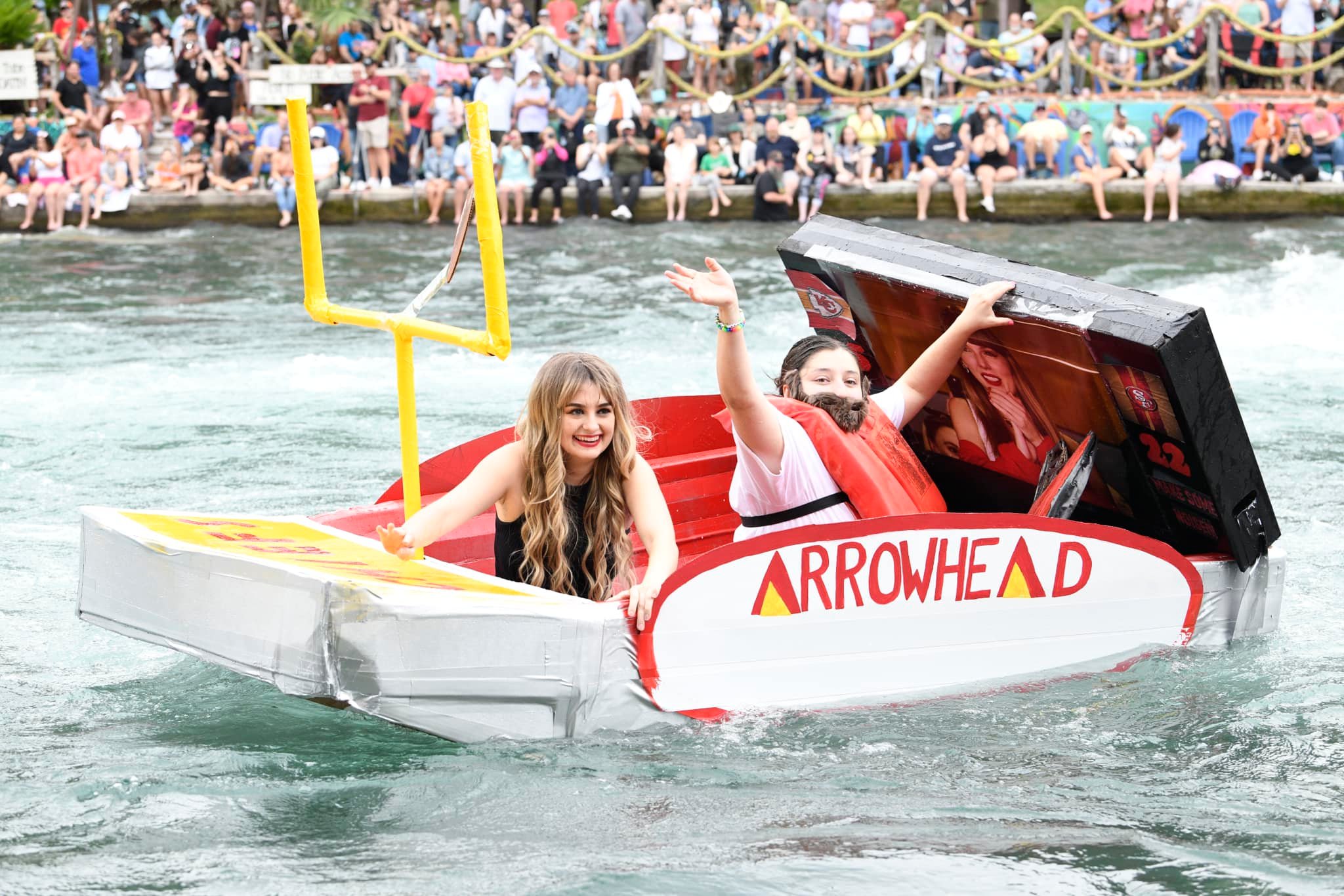 Competitors sail New Braunfels Thru the Chute Boat Race as icons