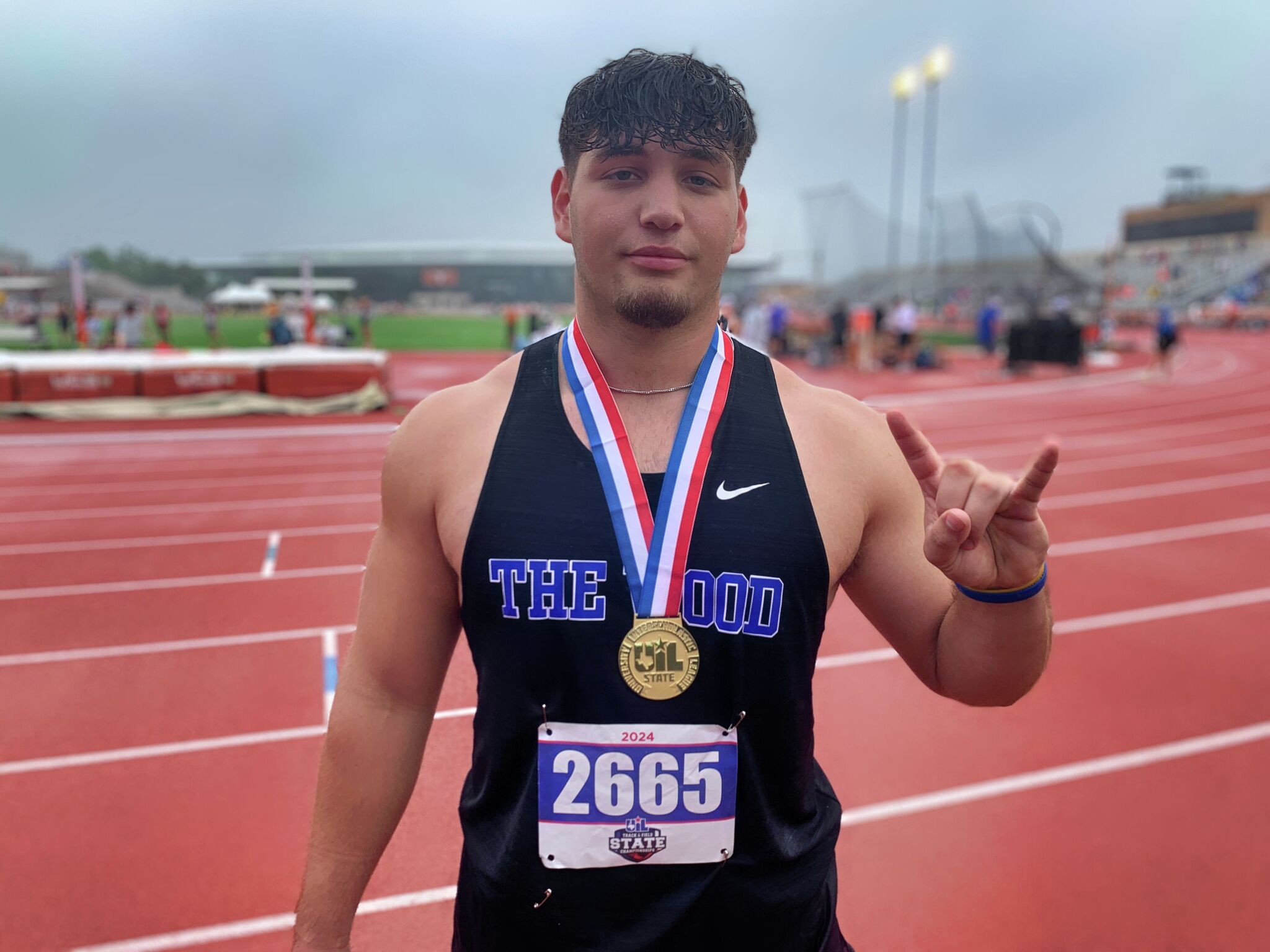 Sacrifices pay off with gold medal for Friendswood thrower.