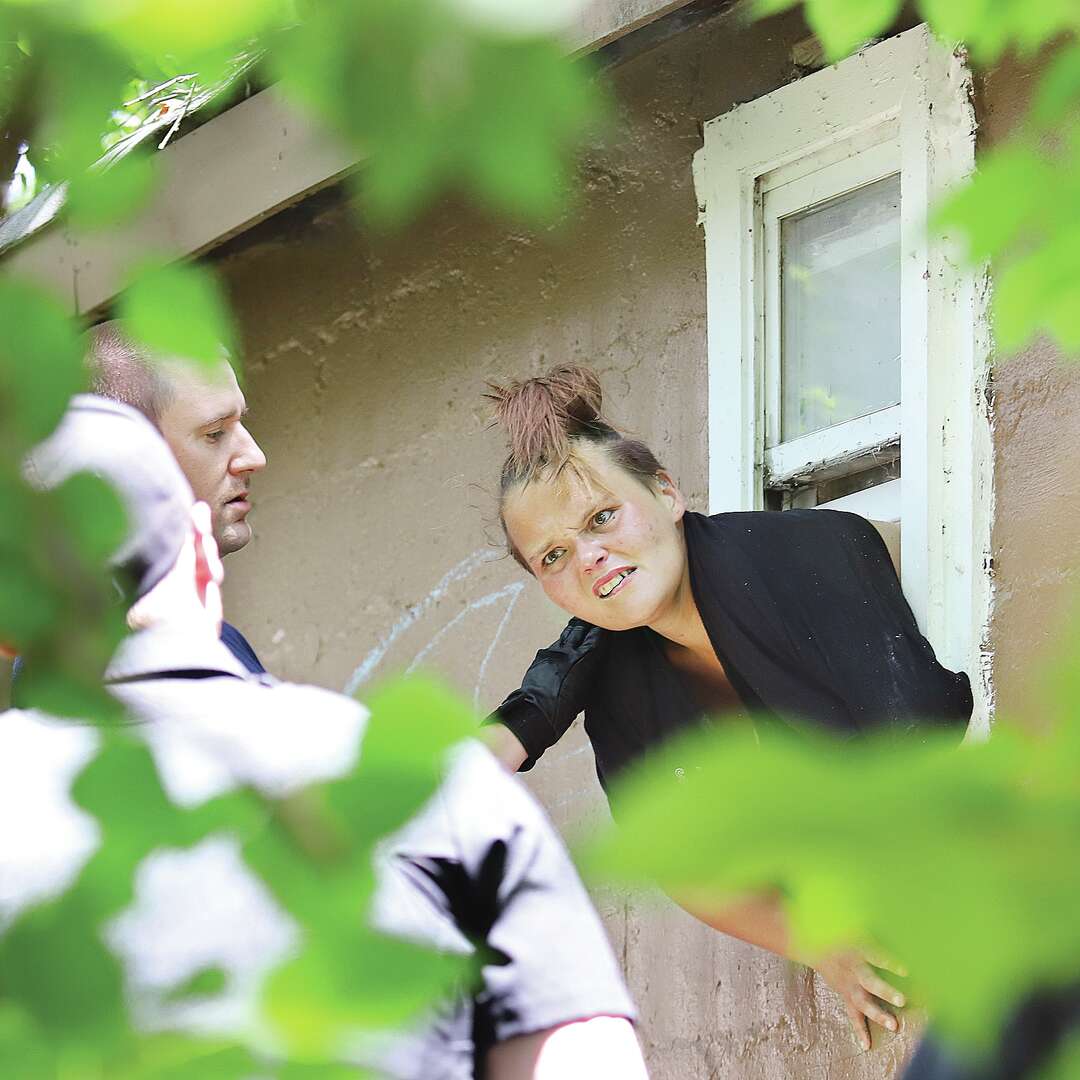 Woman stuck in window rescued by Alton firefighters