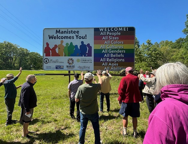 Manistee community gathers for blessing of billboard event
