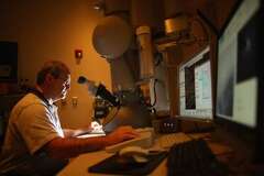 What Did Zacharias Janssen Contribute to Microbiology?