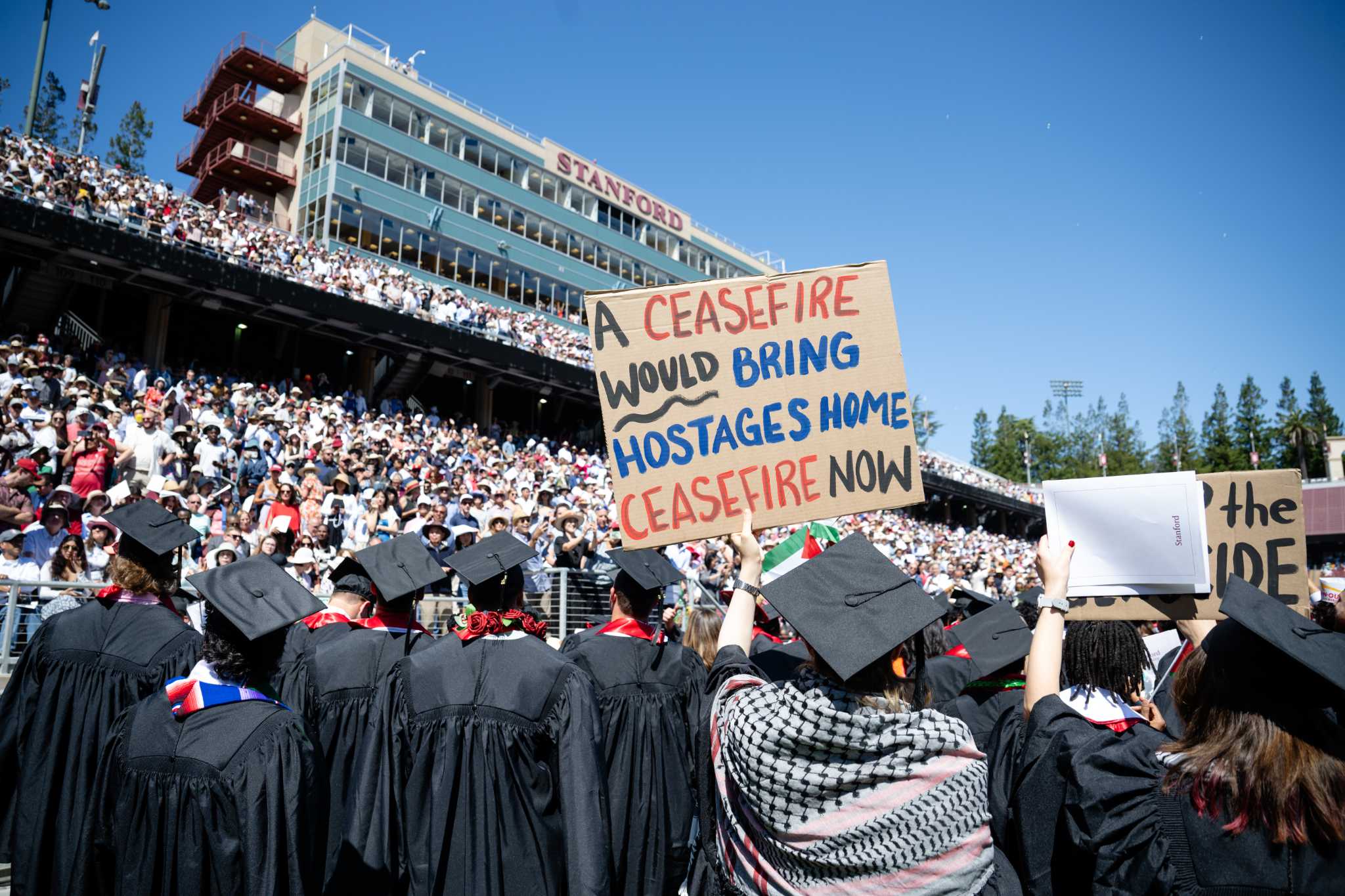 Stanford commencement: Hundreds of graduates walk out to join protest