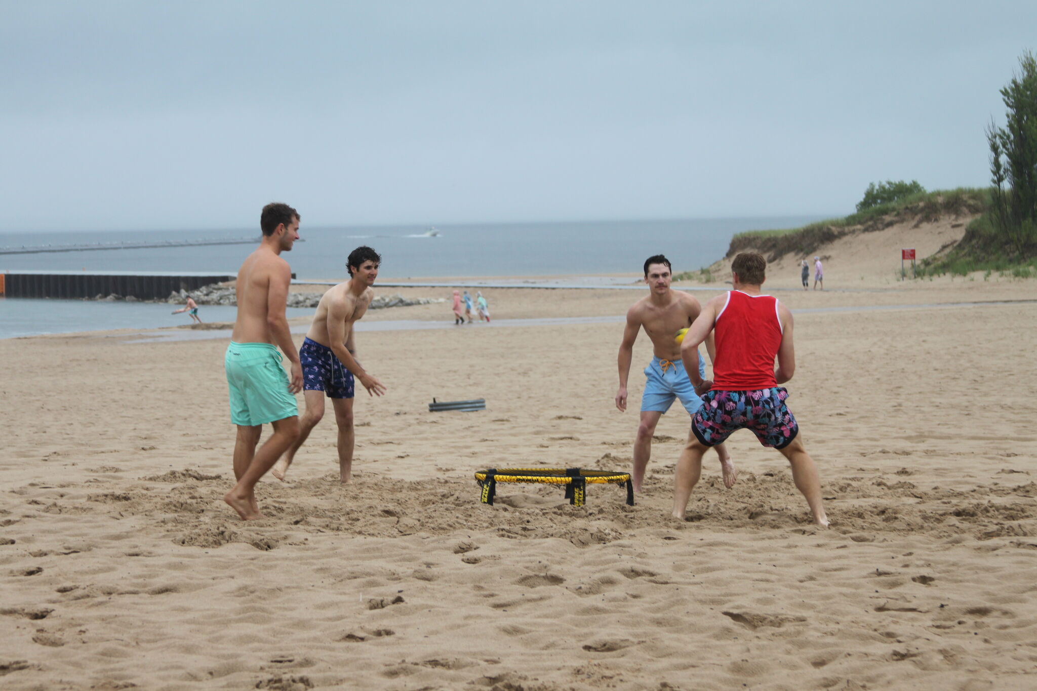 Locals and visitors play in the rain at Manistee's First Street Beach