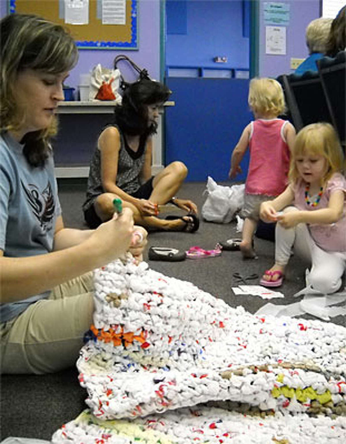 Church members crochet mats for homeless