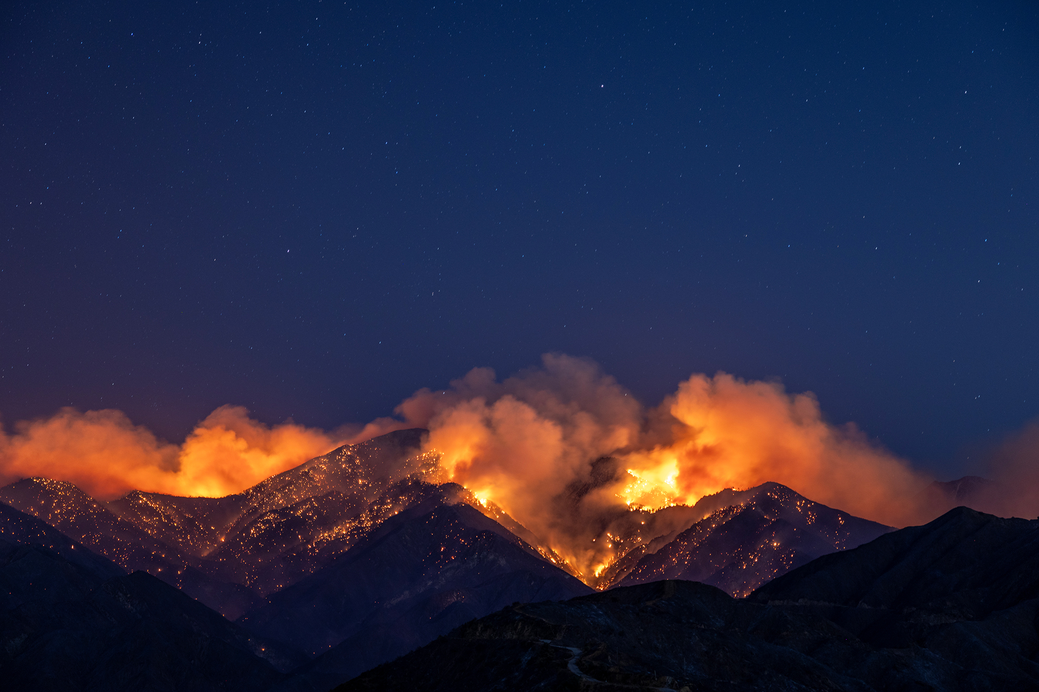 California's largest active wildfire destroys dozens of mountain homes