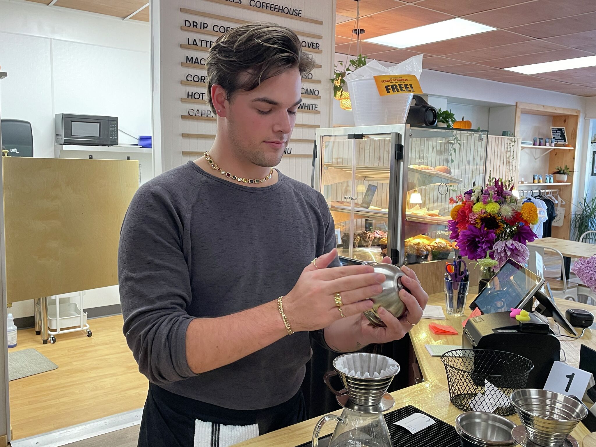Barista Caleb Howard makes a pour-over coffee at Belle's Coffeehouse