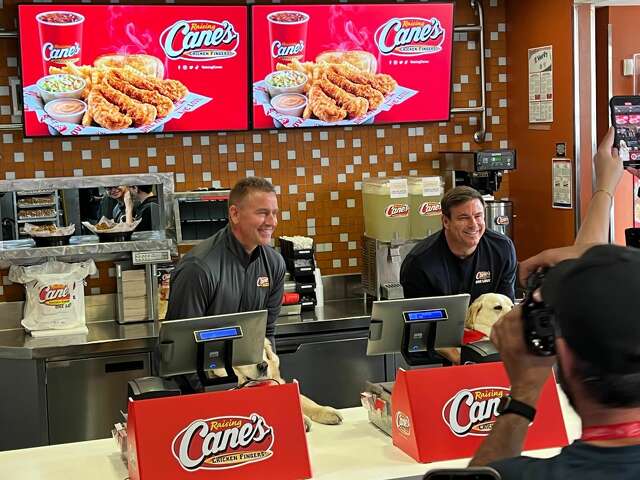 ESPN's Kirk Herbstreit and his dog meet Cane III at Raising Cane's