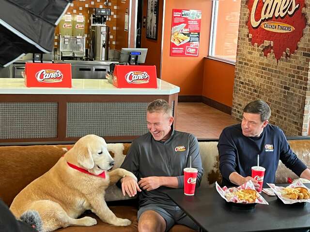 ESPN's Kirk Herbstreit and his dog meet Cane III at Raising Cane's