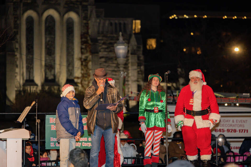 Photos: Santa rappels 22 stories for Stamford's Heights and Lights