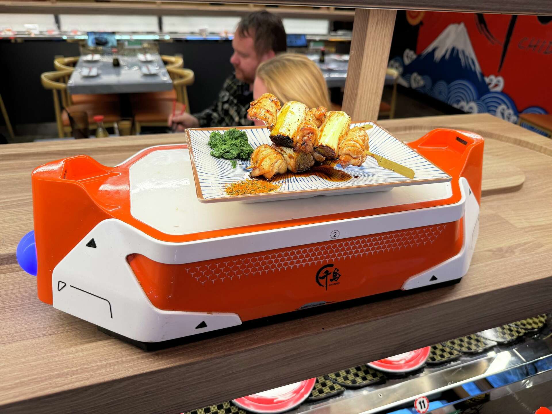 At new revolving sushi spot in Connecticut a robotic train brings food