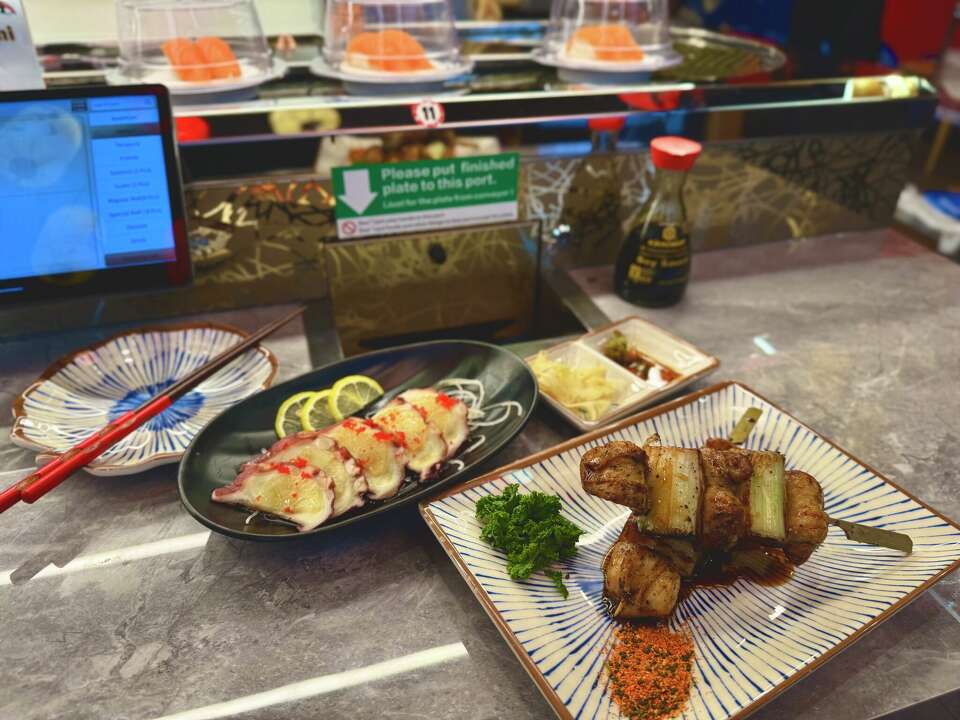 At new revolving sushi spot in Connecticut a robotic train brings food