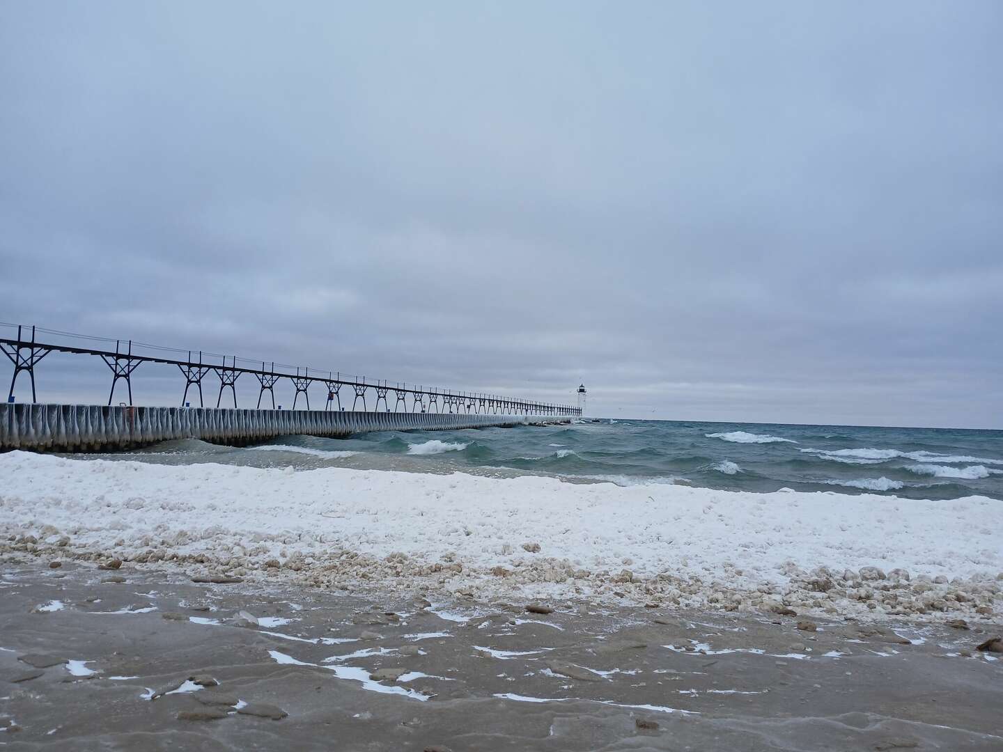 Lake Michigan ice balls roll into Manistee's lakeshore after high wind