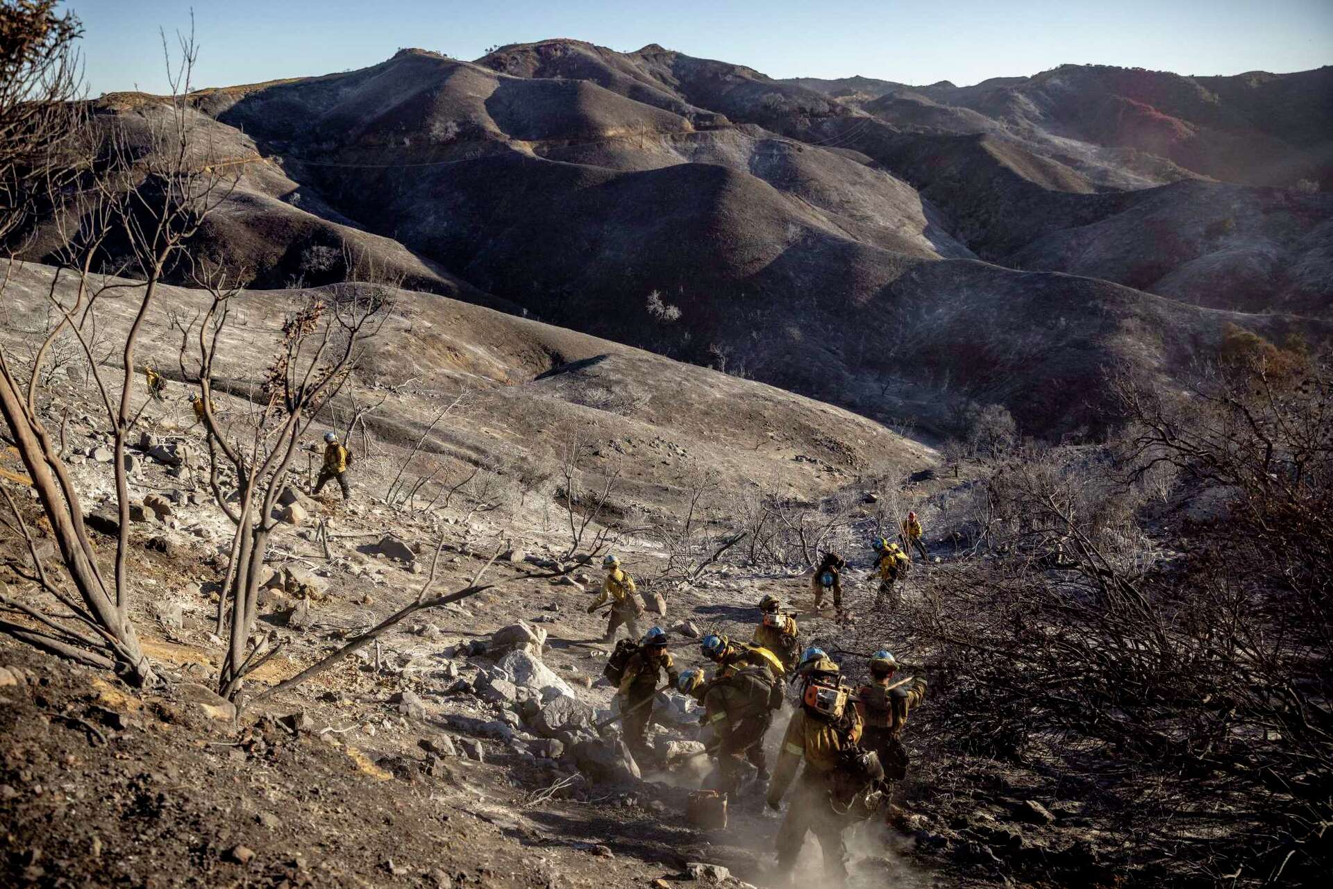 How are Palisades firefighters guarding against reignition? By hand