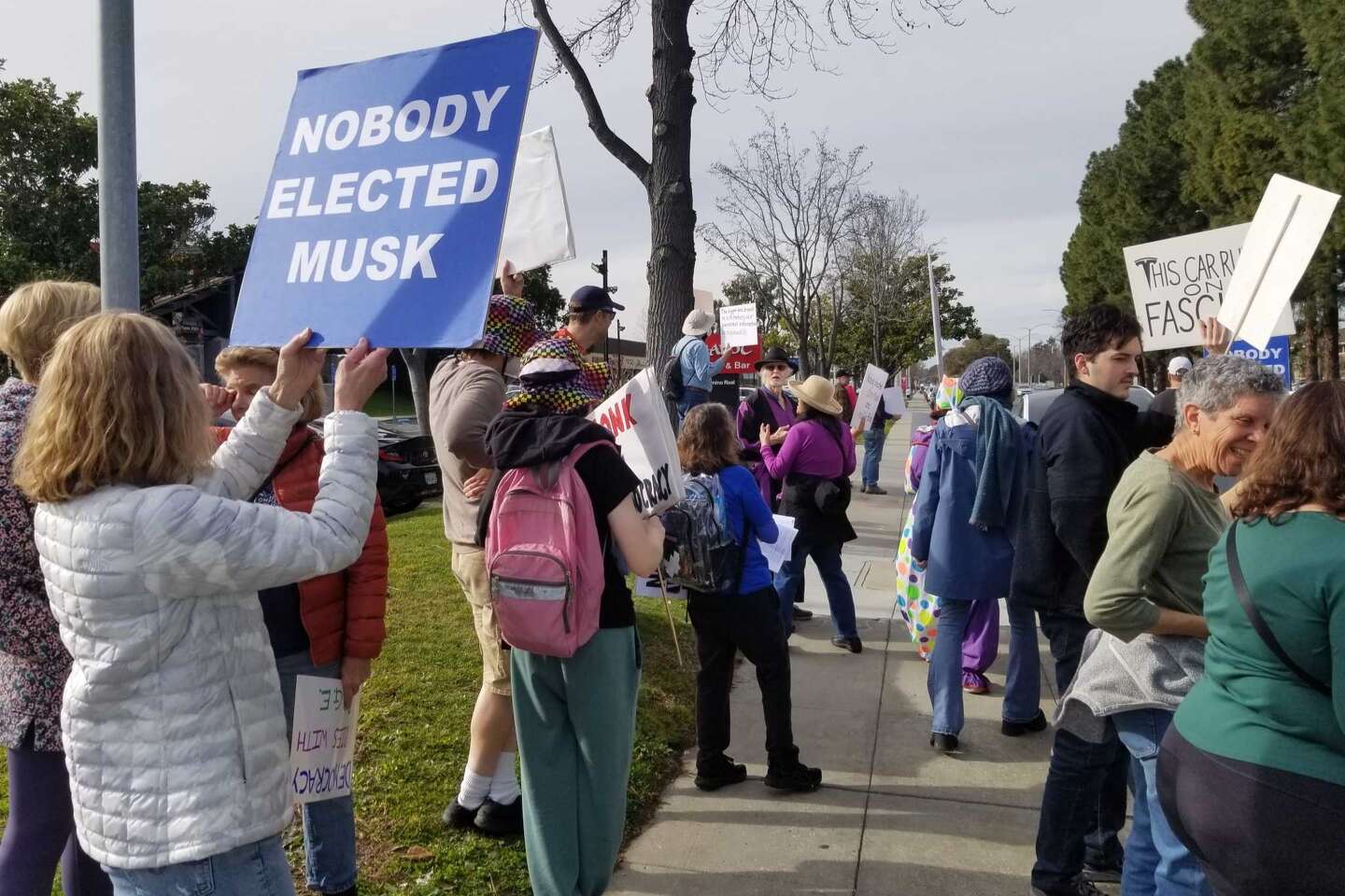 Bay Area protests outside Tesla showrooms seek to dissuade buyers