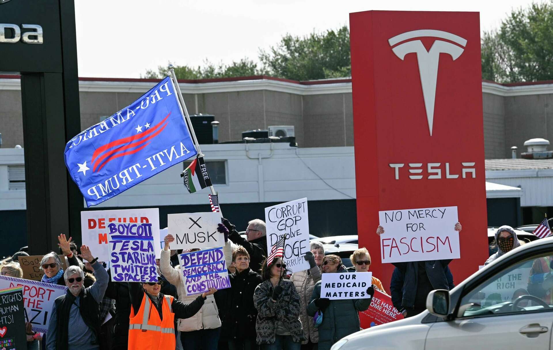 Hundreds protest outside Milford Tesla showroom Saturday