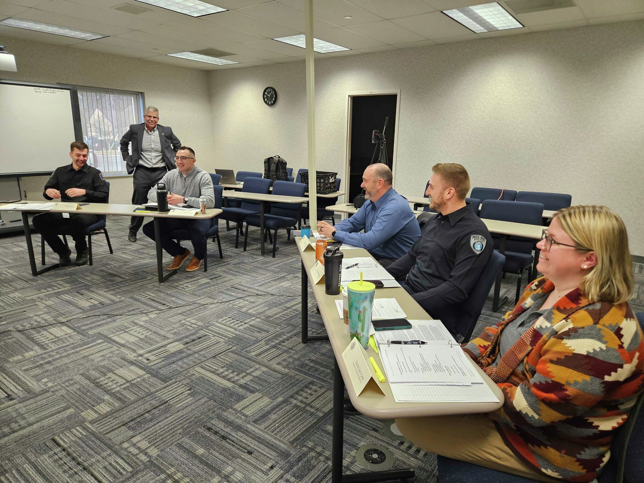 Law enforcement and dispatch officials take part in press training