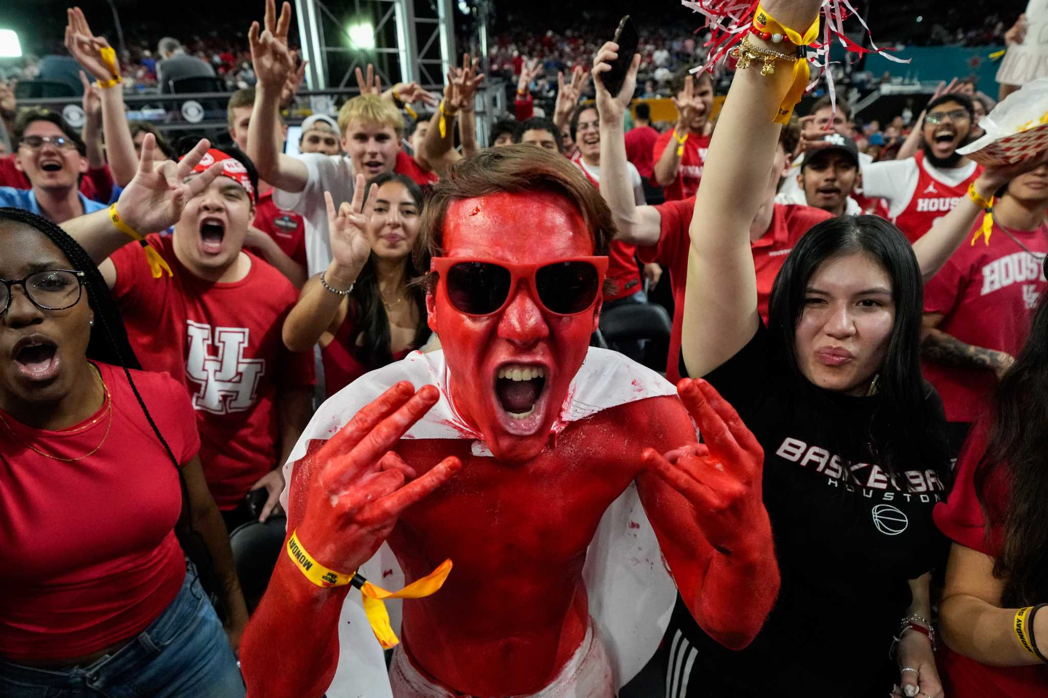 Student celebrates Houston Cougars basketball by painting himself red