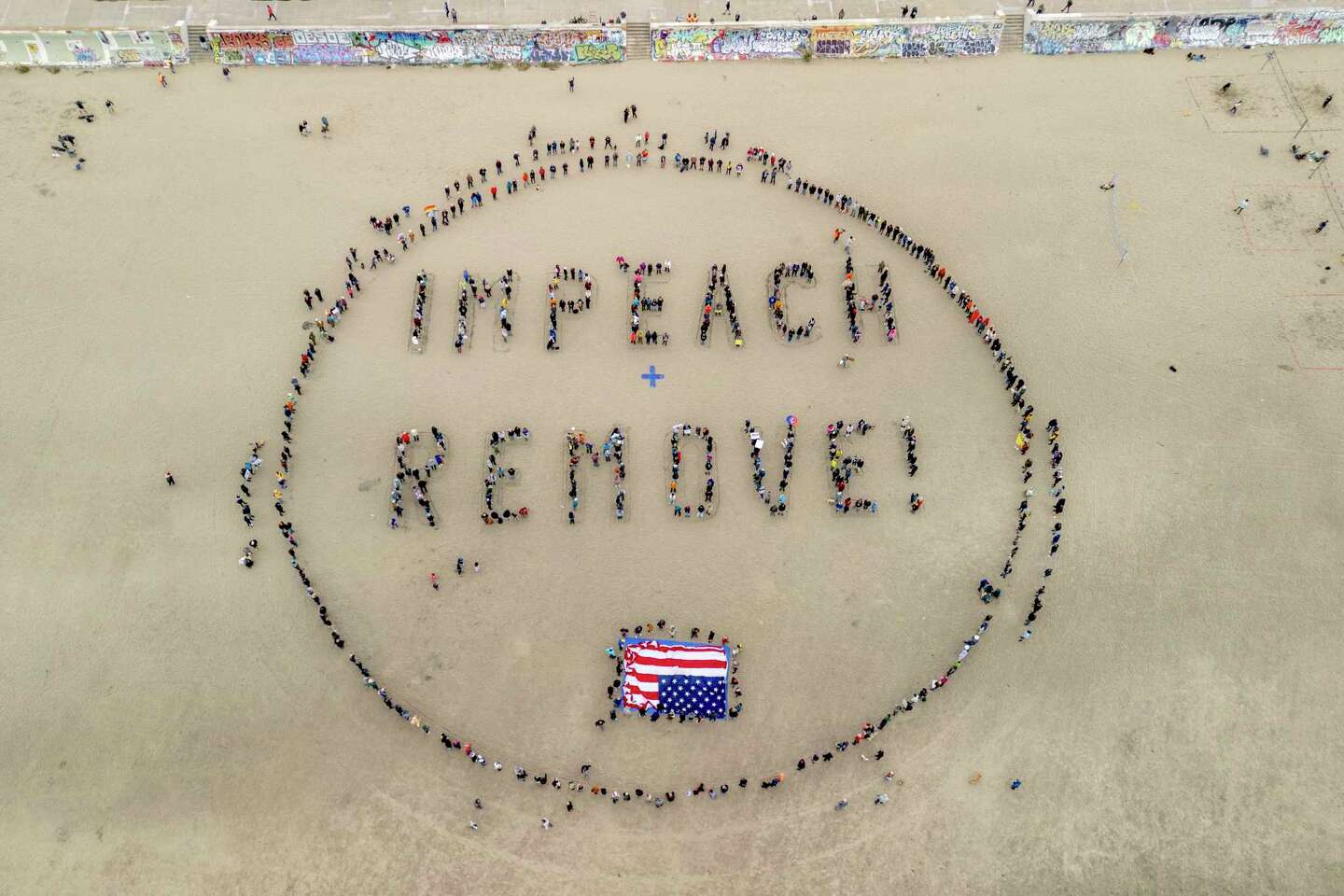Photos: Hundreds of SF protesters form human banner to defy Trump