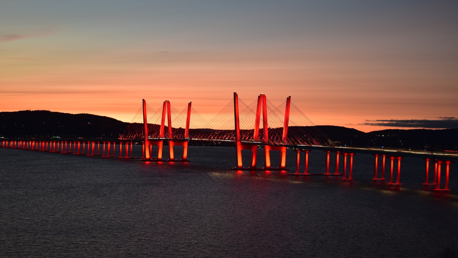 Why is the Governor Mario M. Cuomo Bridge glowing red today?