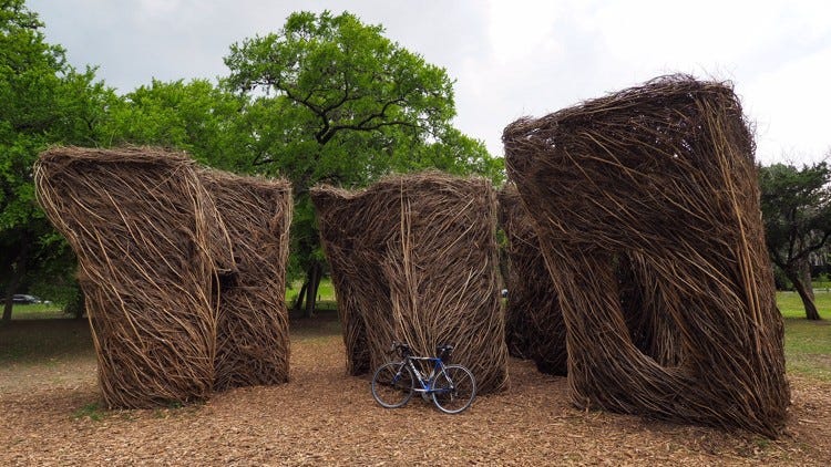 At Pease Park, explore a village of twig huts