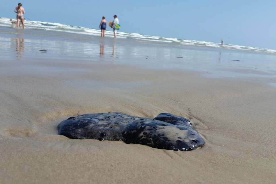 What to know about sticky tar balls invading Texas Gulf Coast beaches
