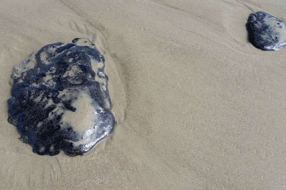 What to know about sticky tar balls invading Texas Gulf Coast beaches