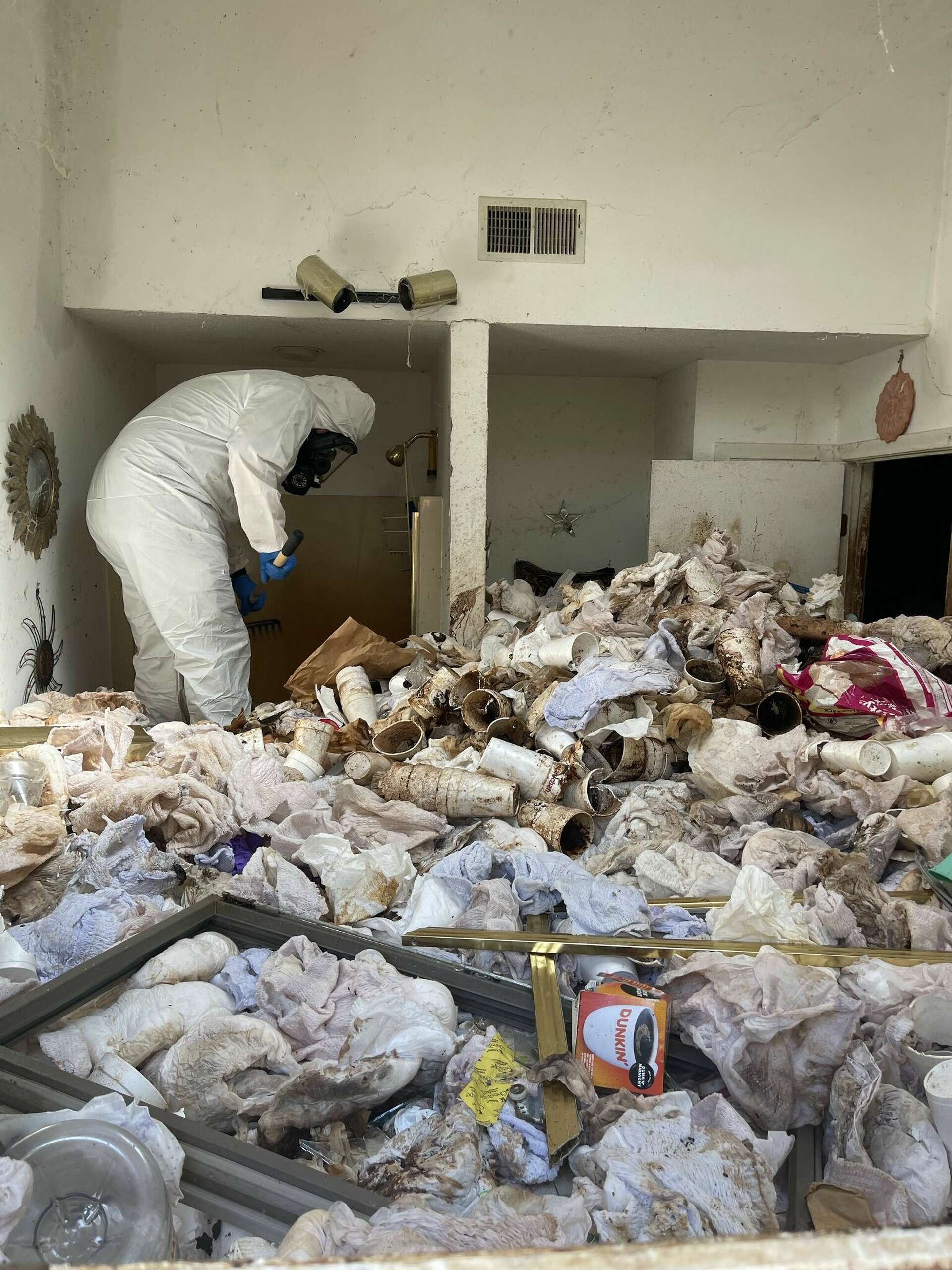 CT house where body found had debris piled high, photos, videos show