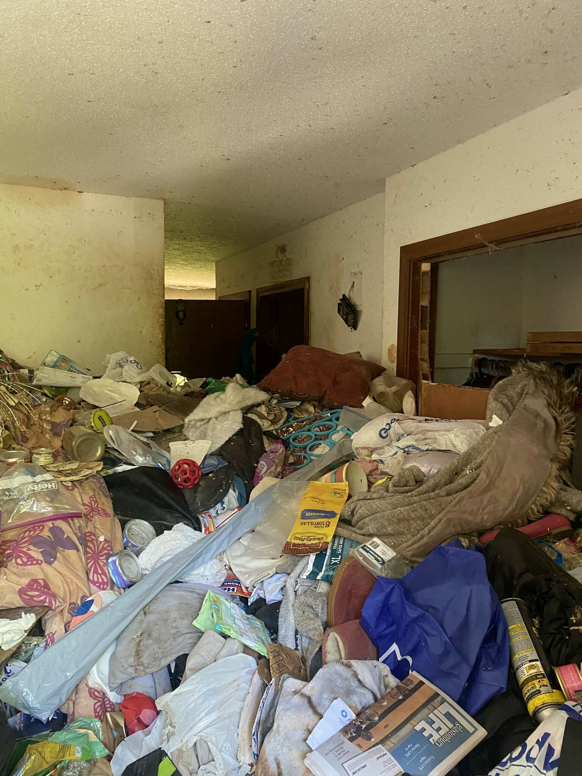CT house where body found had debris piled high, photos, videos show
