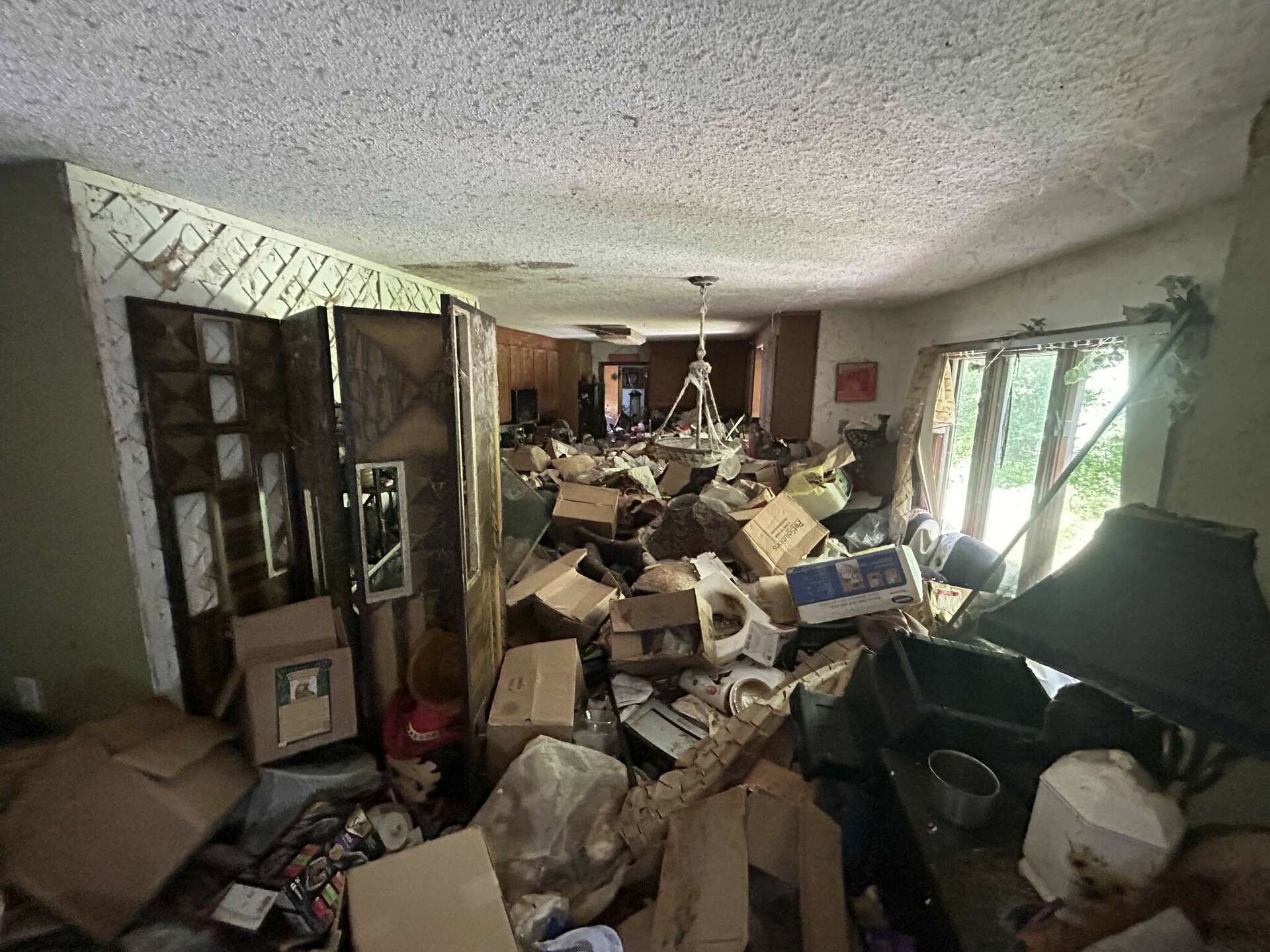CT house where body found had debris piled high, photos, videos show