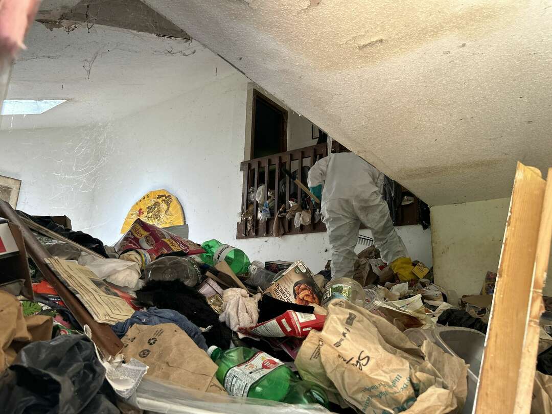 CT house where body found had debris piled high, photos, videos show