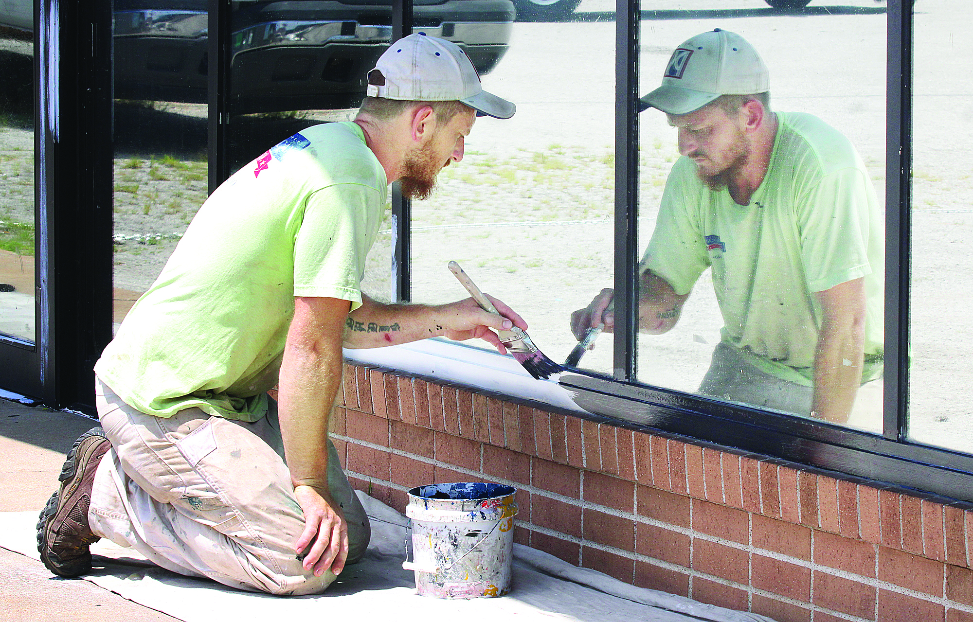 Rick Davis and his reflection paint Alton banquet center