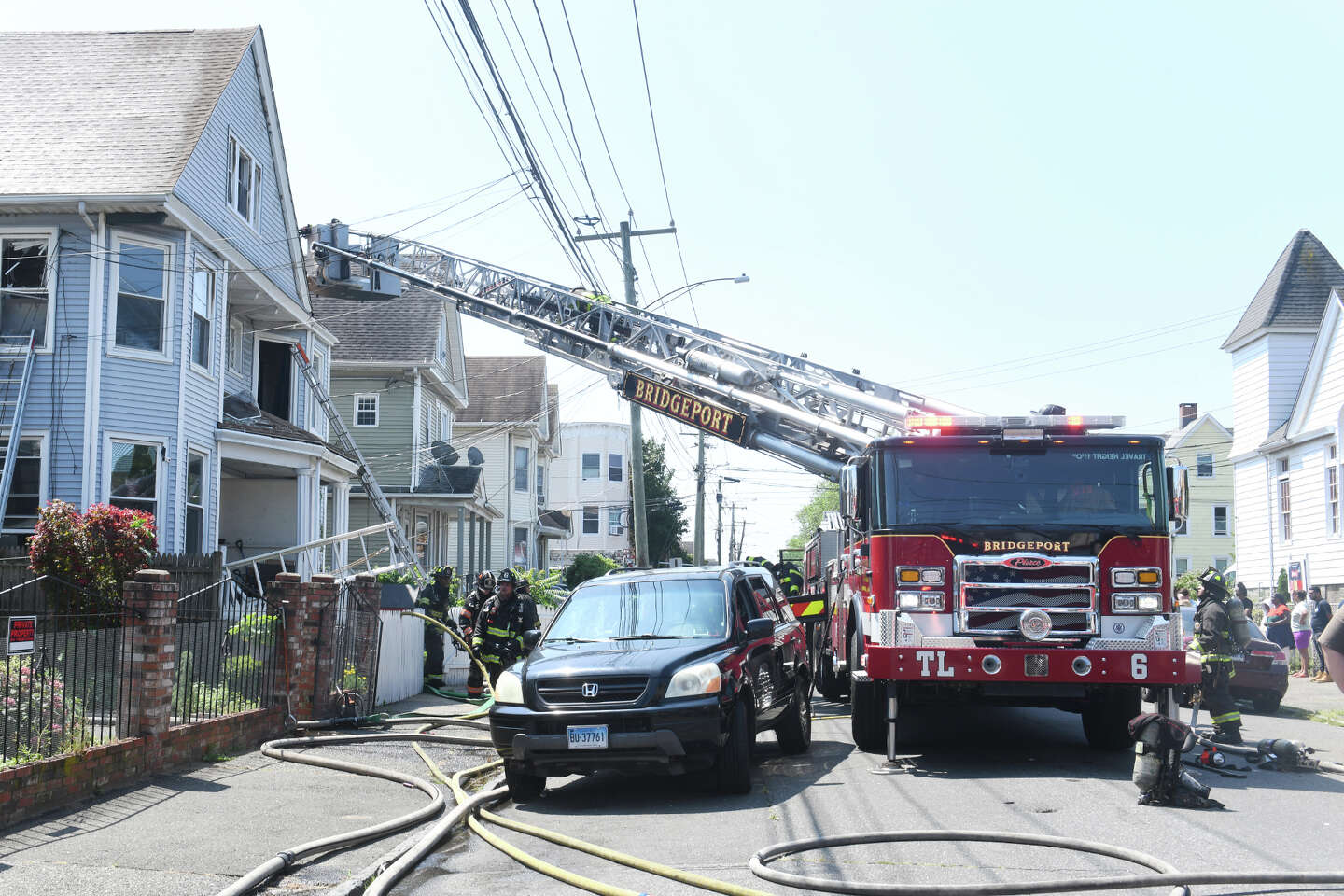 Bridgeport firefighters rescue 3 from roof of burning home: Official