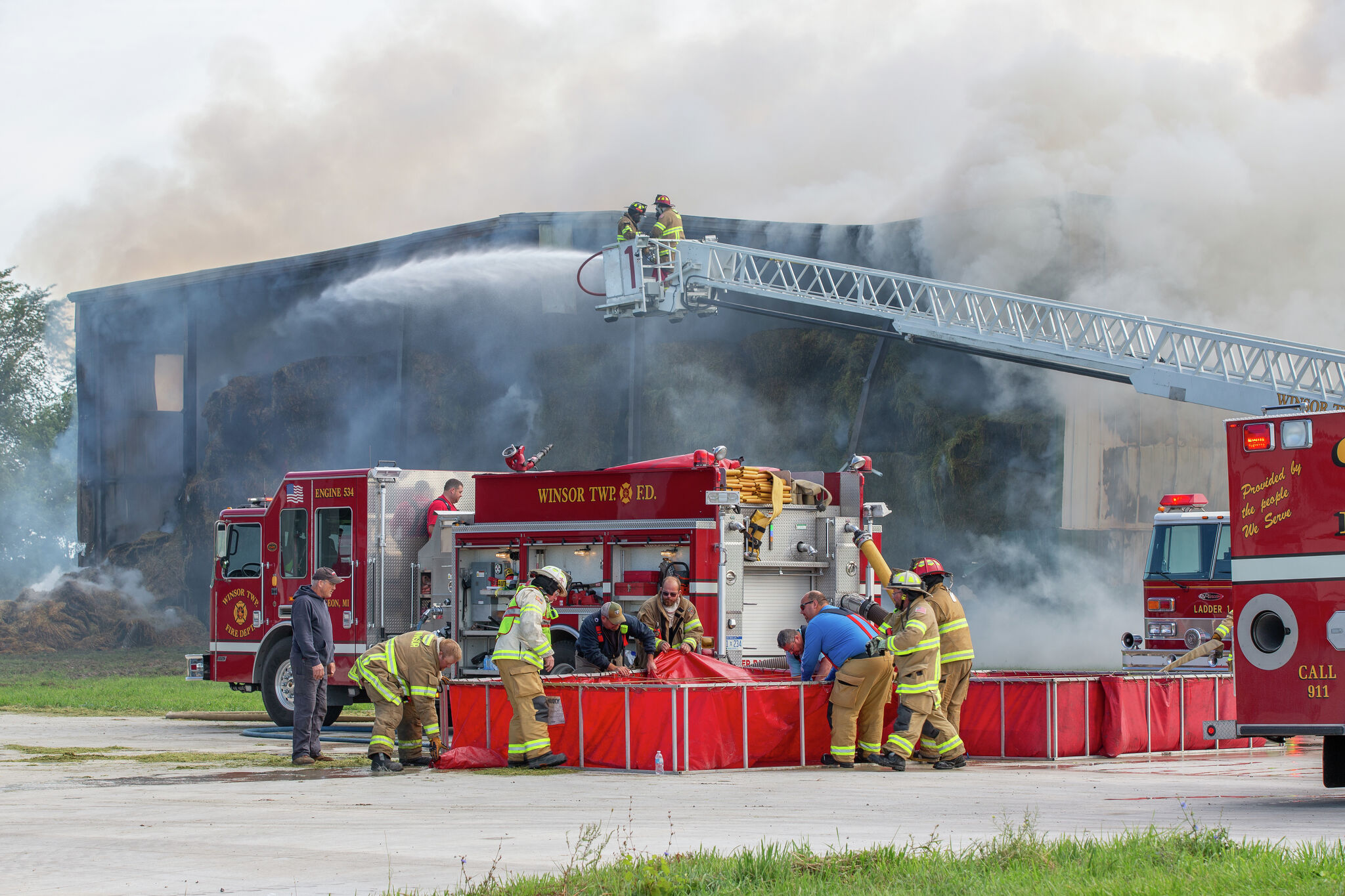Bay Port hay barn fire will burn for weeks