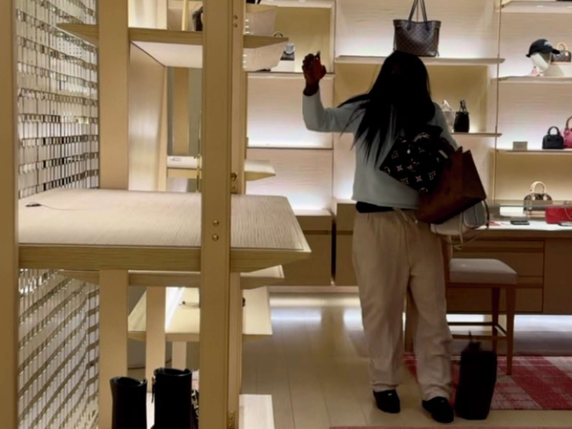 Camera shows man in wig rob Texas Louis Vuitton store