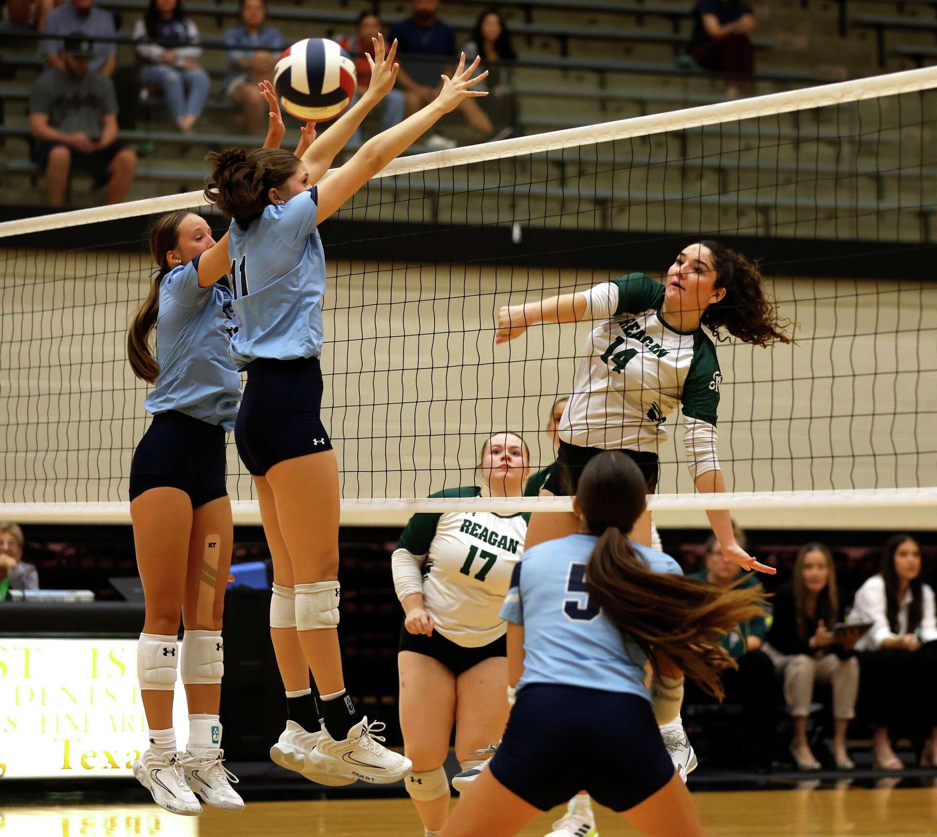Reagan volleyball grinds out four-set victory against rival Johnson