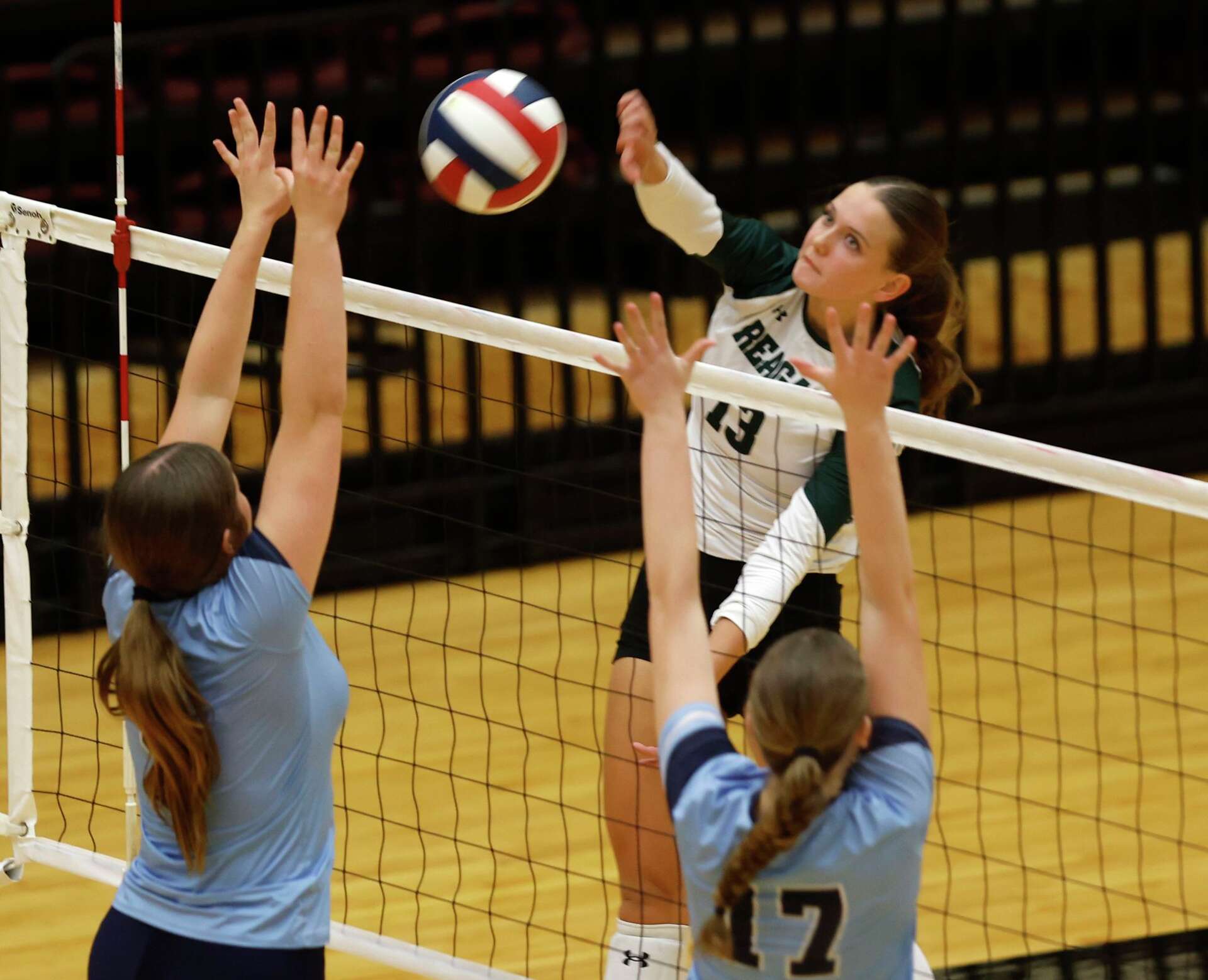 Reagan volleyball grinds out four-set victory against rival Johnson