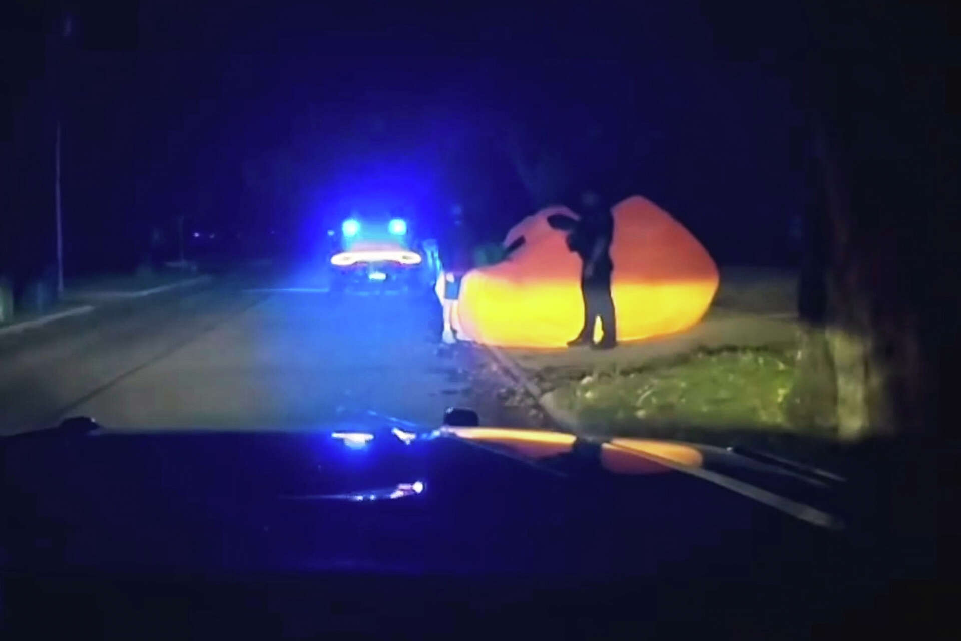 Police caught on camera chasing giant runaway inflatable pumpkin