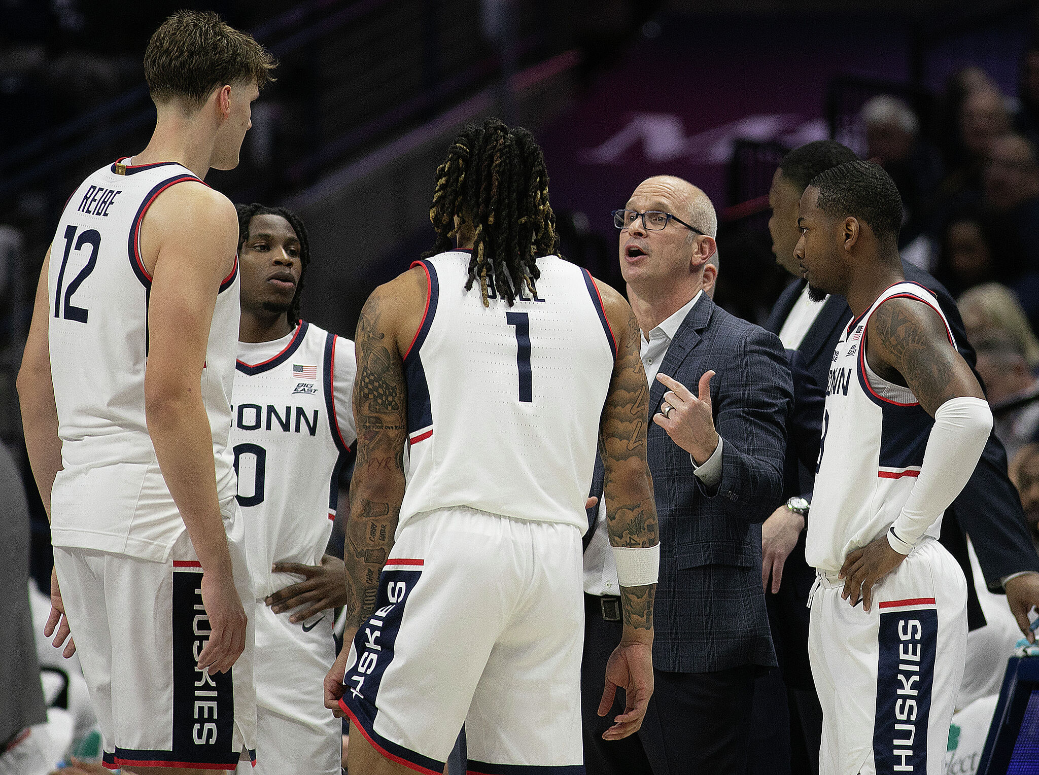 How much did UConn pay for matchups with mid-major opponents?