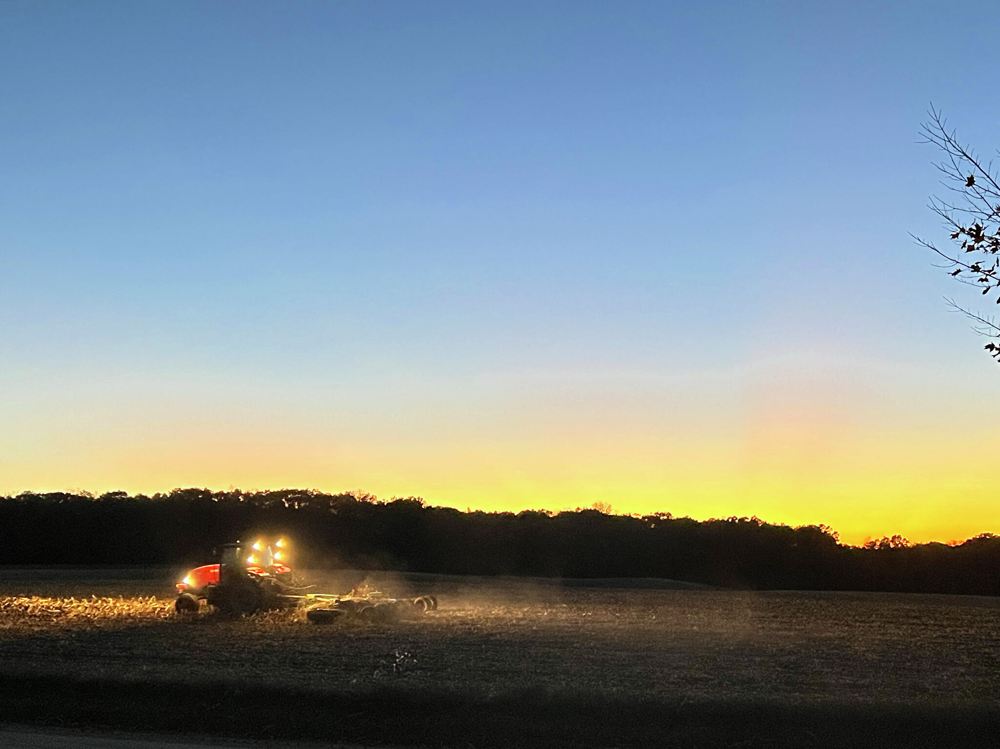 Mecosta County West Michigan farmer works during November sunset