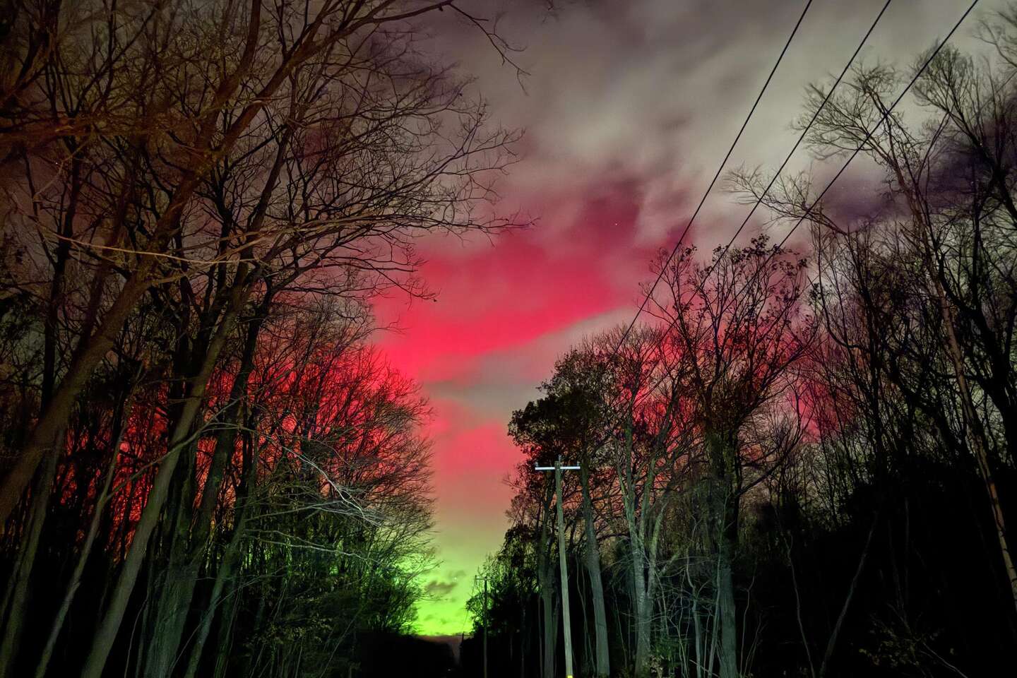 Northern lights glow over Connecticut in reds, pinks and greens