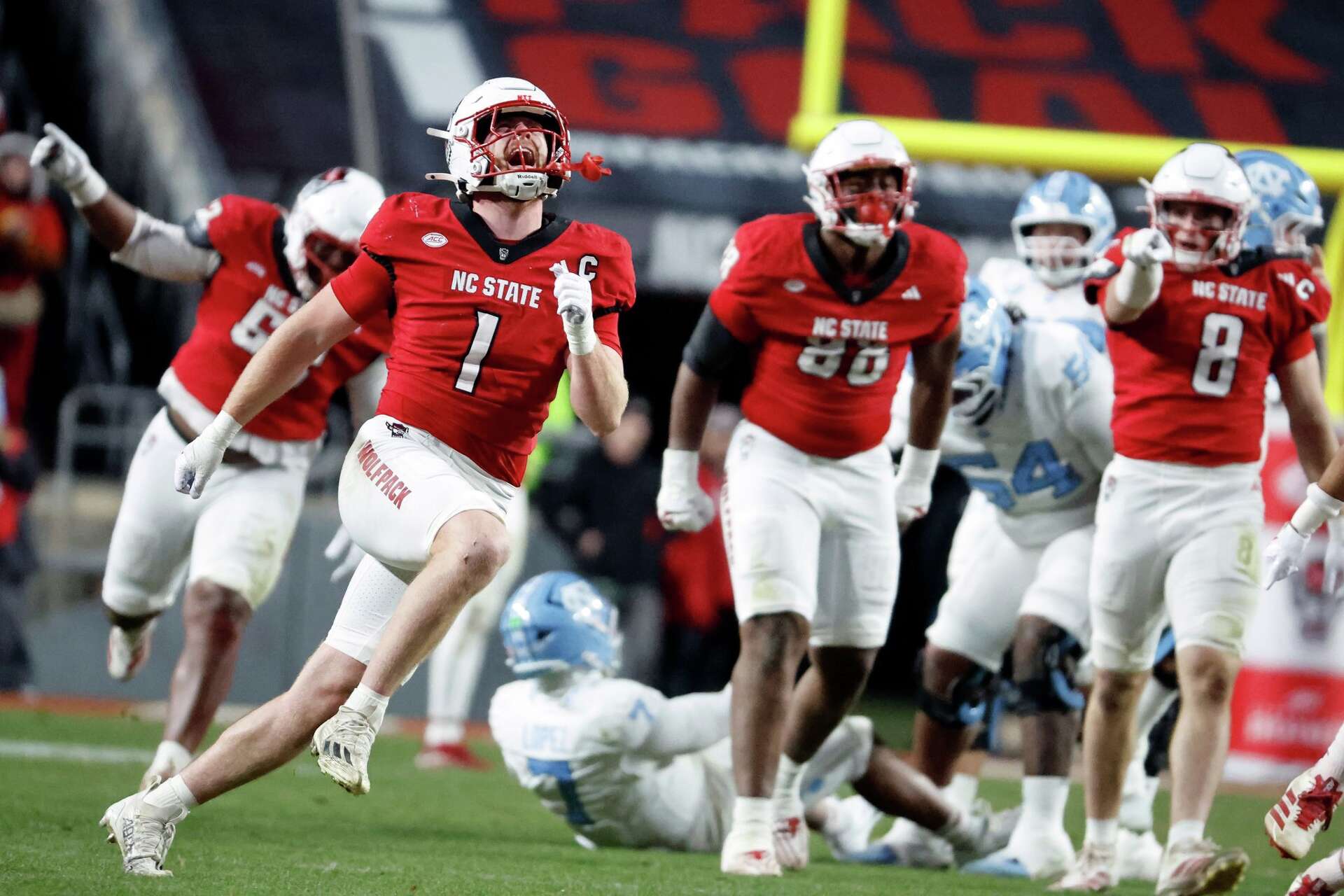 Wilson runs for 4 TDs as NC State beats UNC 42-19, winning rivalry game ...