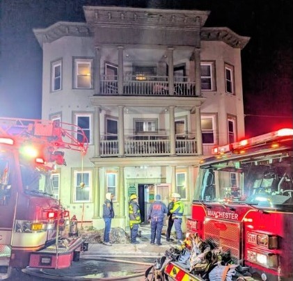 One dead, three rescued, one in custody in Manchester blaze